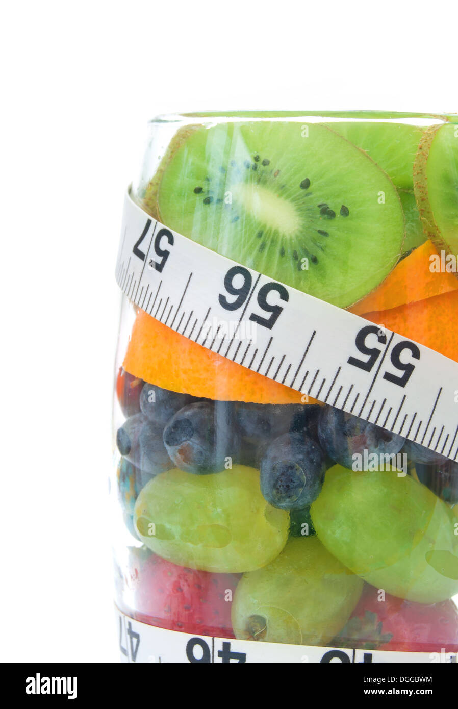 Five fruits packed into a glass with a tape measure Stock Photo - Alamy