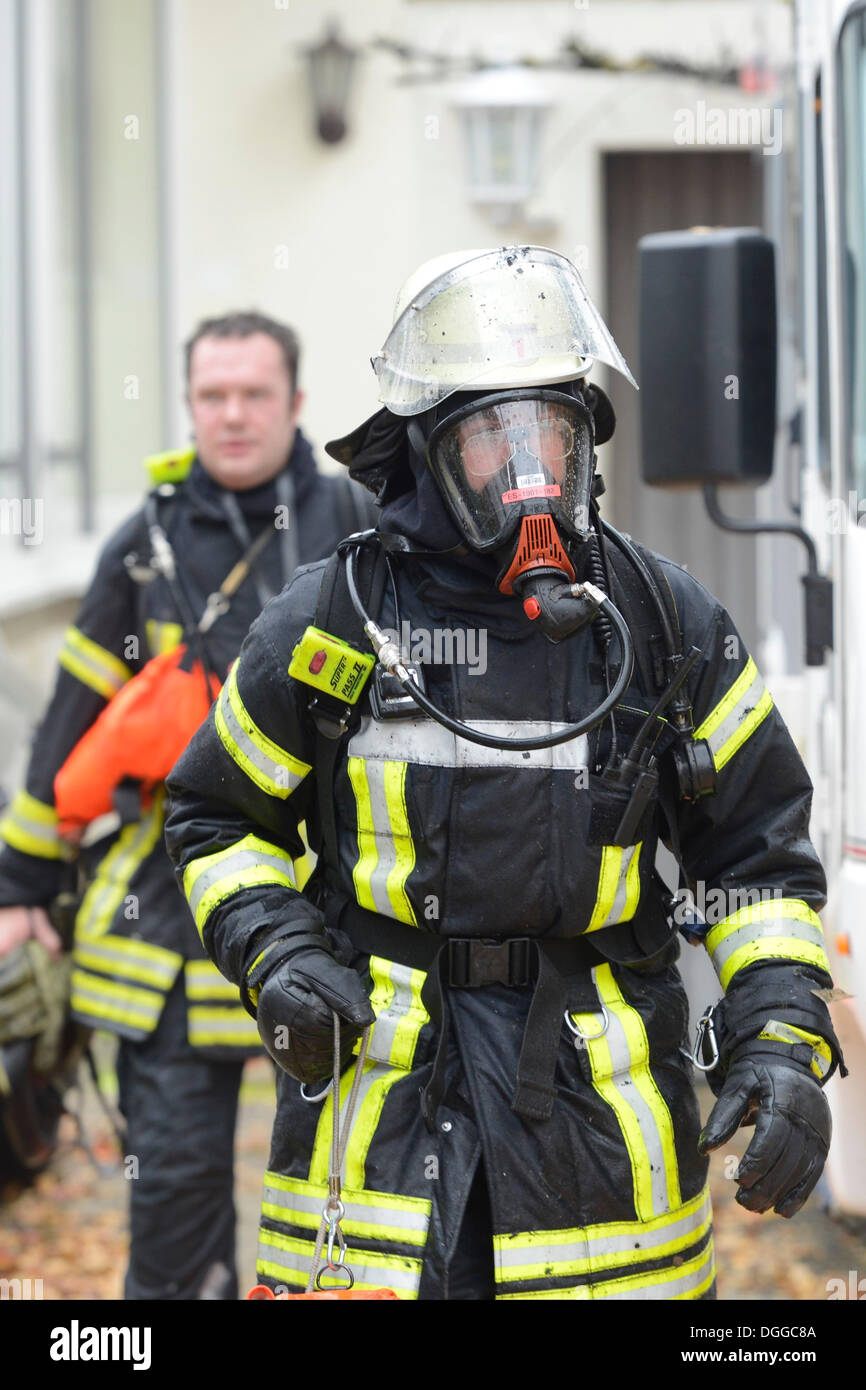 Firefighter wearing breathing equipment during a roof fire, Aichwald ...