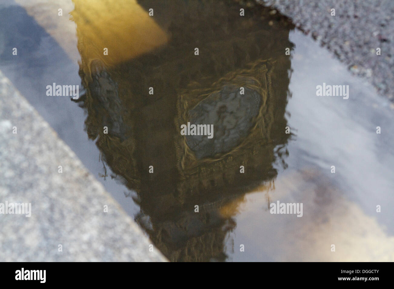 London UK. 21st Oct, 2013. Big Ben reflection in a water puddle on a ...
