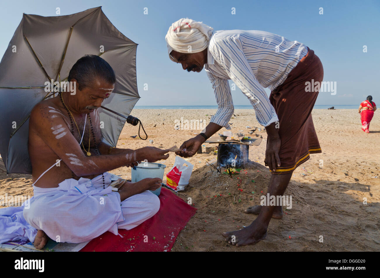 Local priest receiving money after leading a religious ceremony on the ...