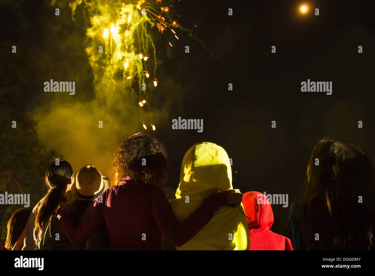 Group of people watching firework display Stock Photo - Alamy
