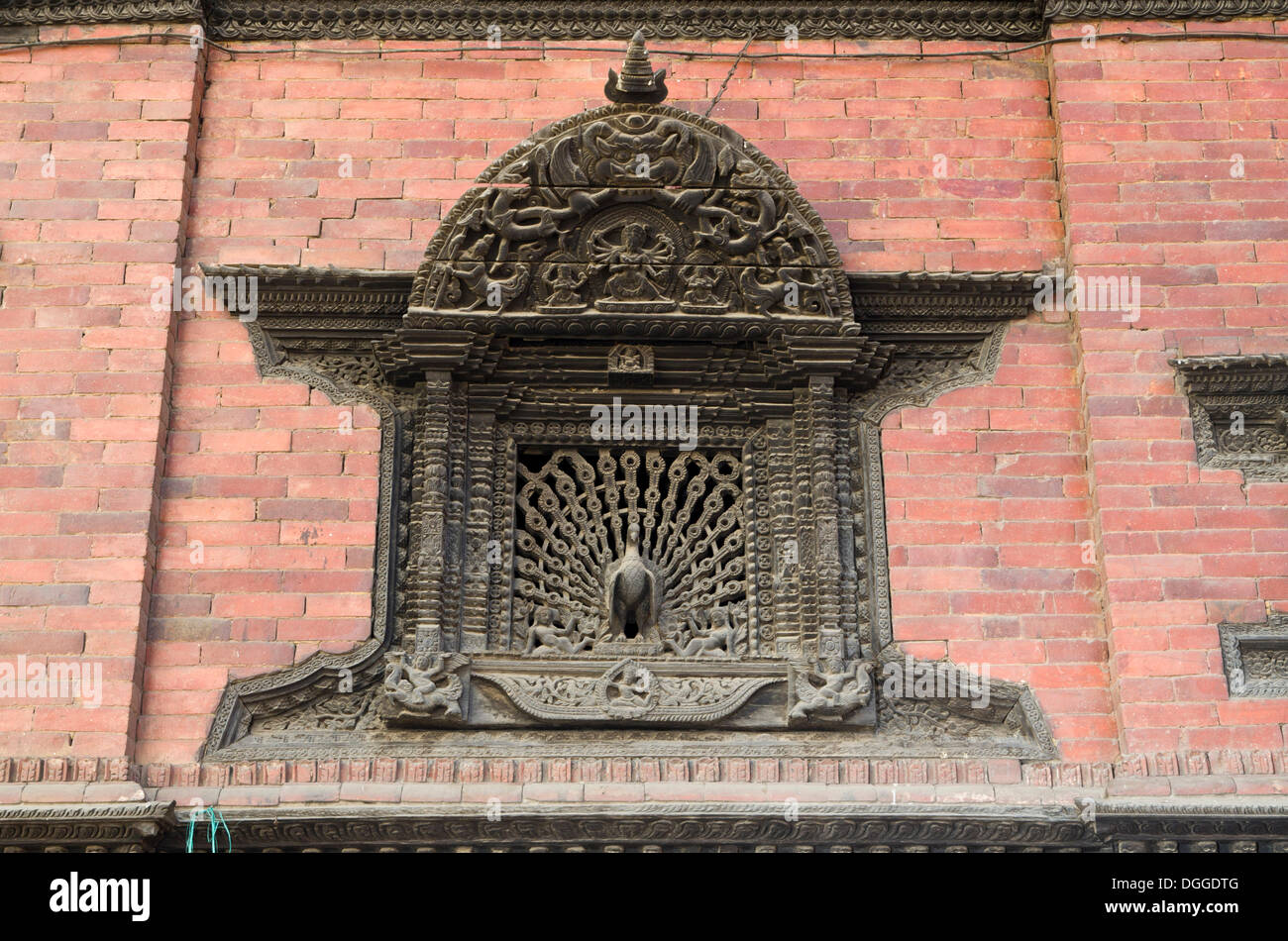 Ornate carved wooden window with a peacock sculpture, Kathmandu Valley ...