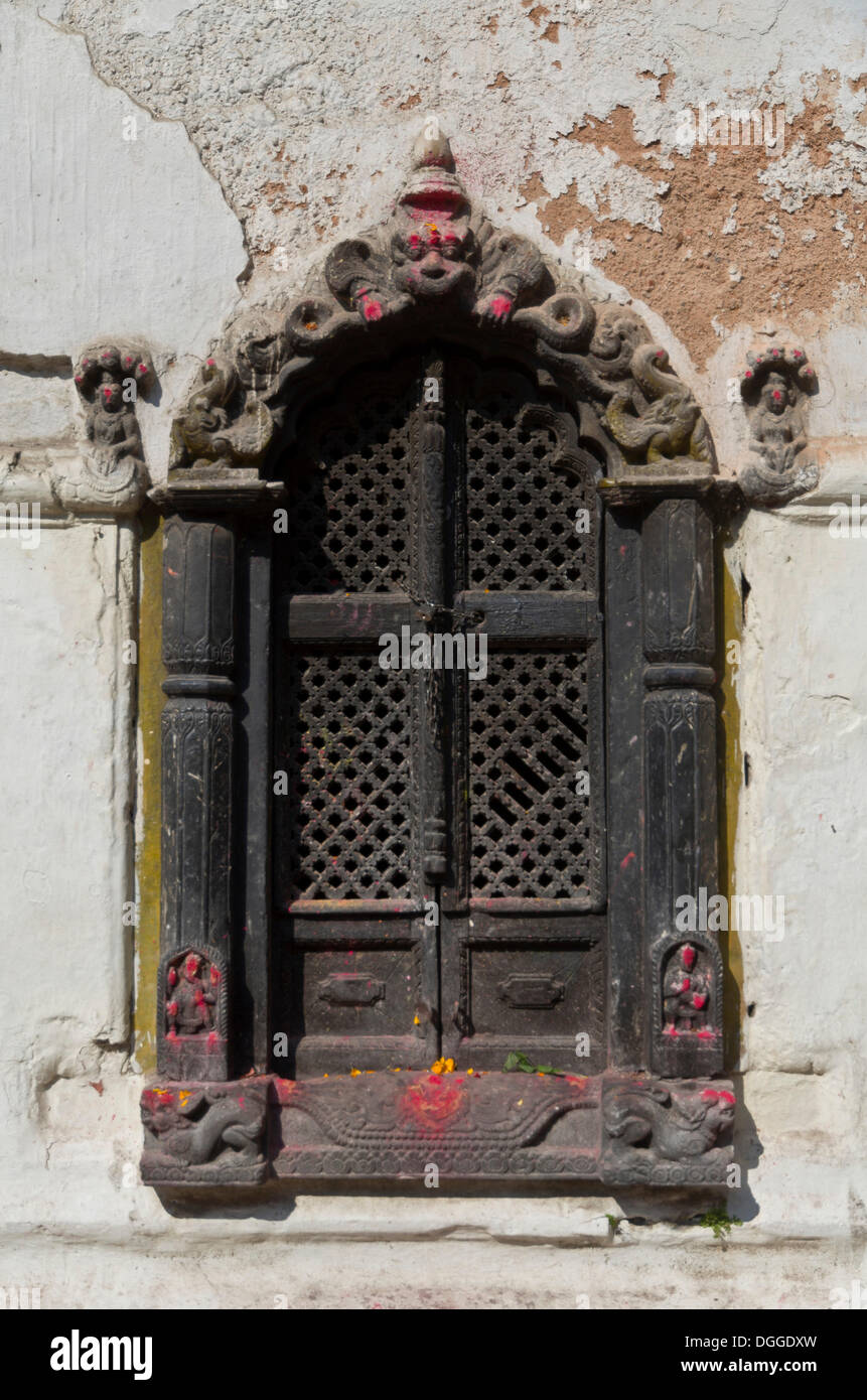 Ornate carved wooden window of a small shrine in the hills above ...