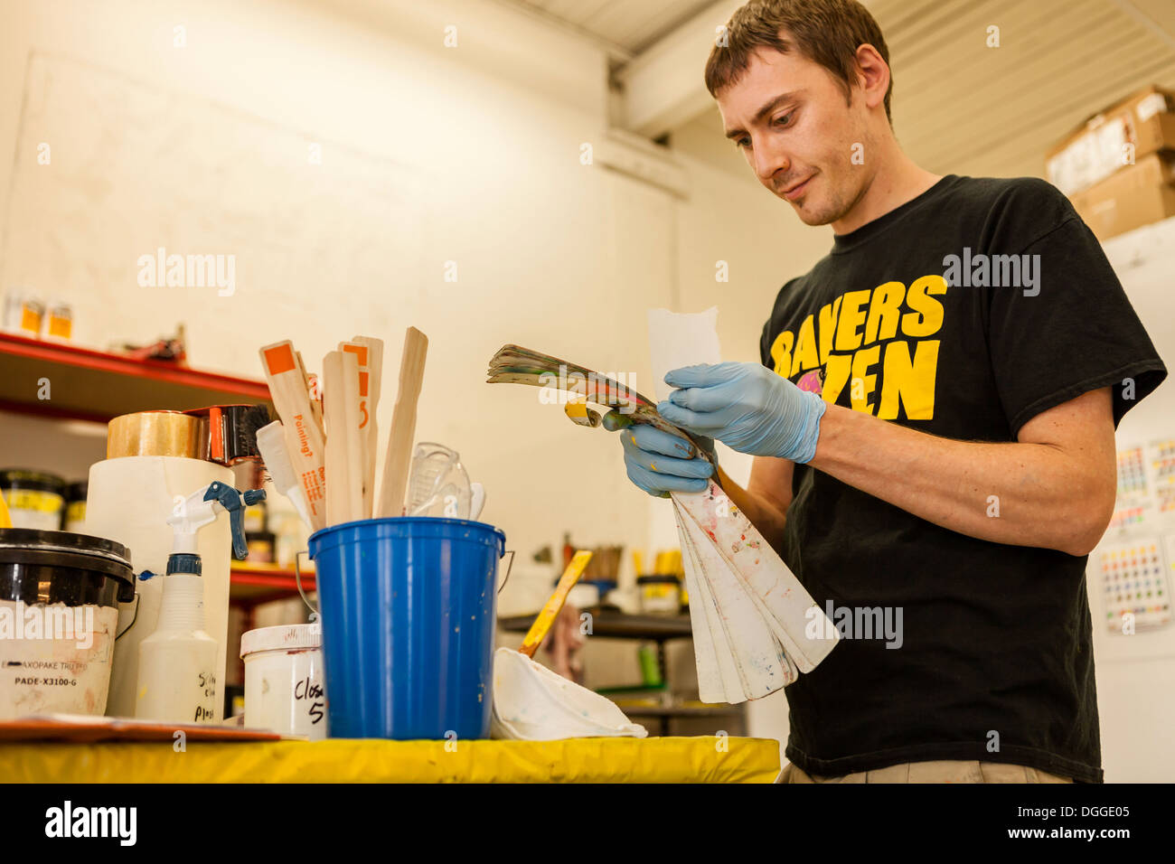 Worker looking at swatches in screen print workshop Stock Photo - Alamy