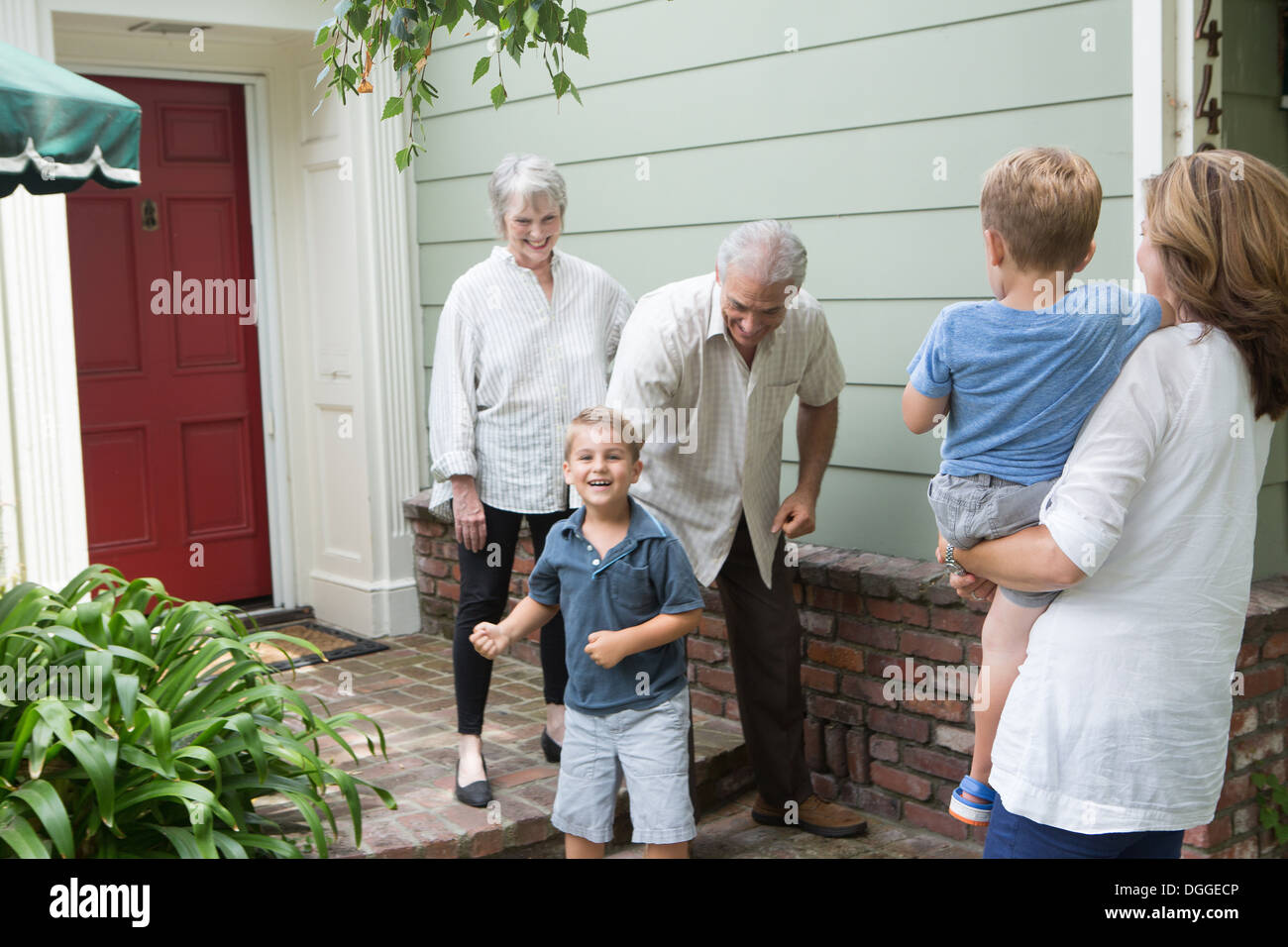 Senior couple greeting family at home Stock Photo - Alamy