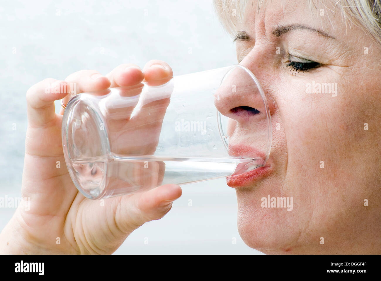 Woman drinking water Stock Photo - Alamy