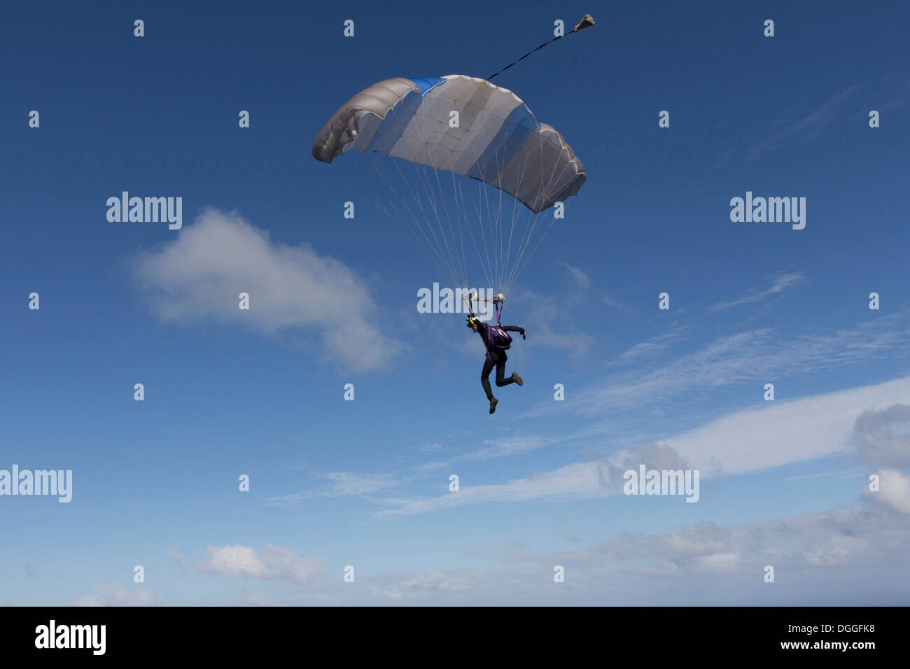 Male skydiver steering parachute Stock Photo - Alamy