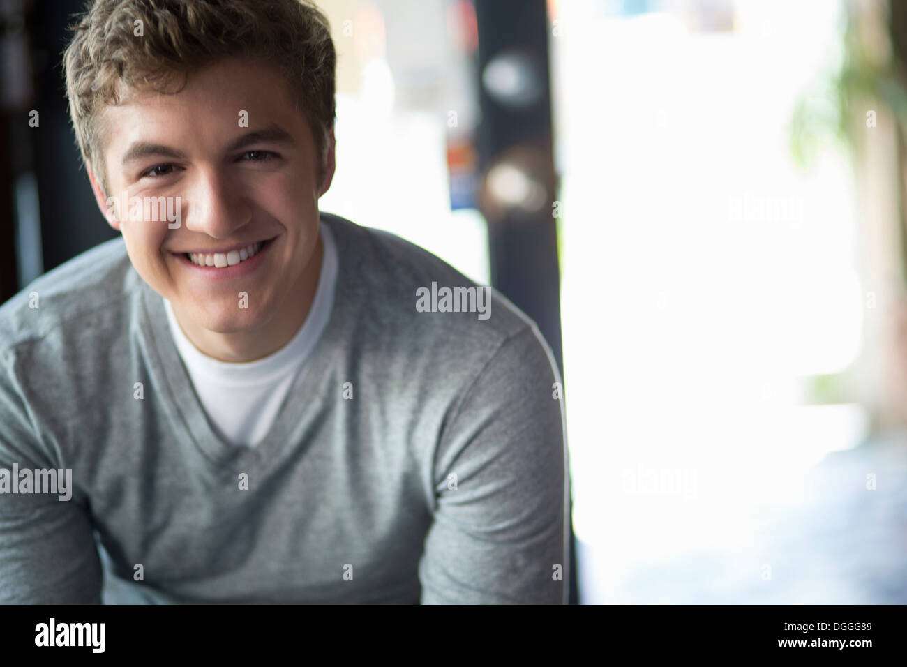 Portrait of young man in cafe Stock Photo - Alamy