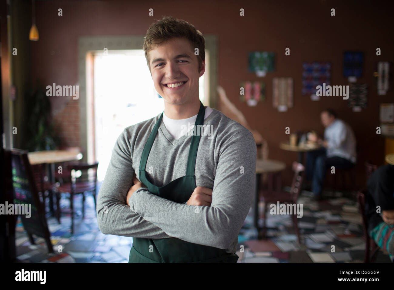 Portrait of young waiter in coffee house Stock Photo - Alamy