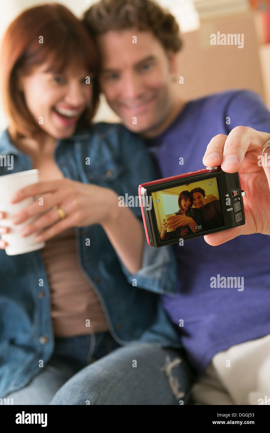 Couple taking self portrait whilst moving house Stock Photo - Alamy