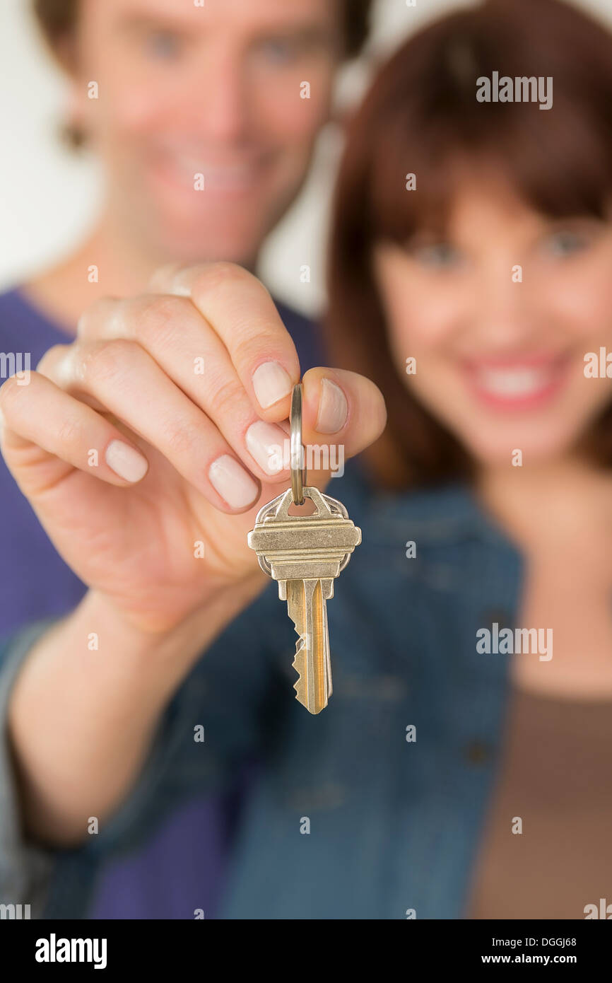 Couple holding new door key Stock Photo - Alamy