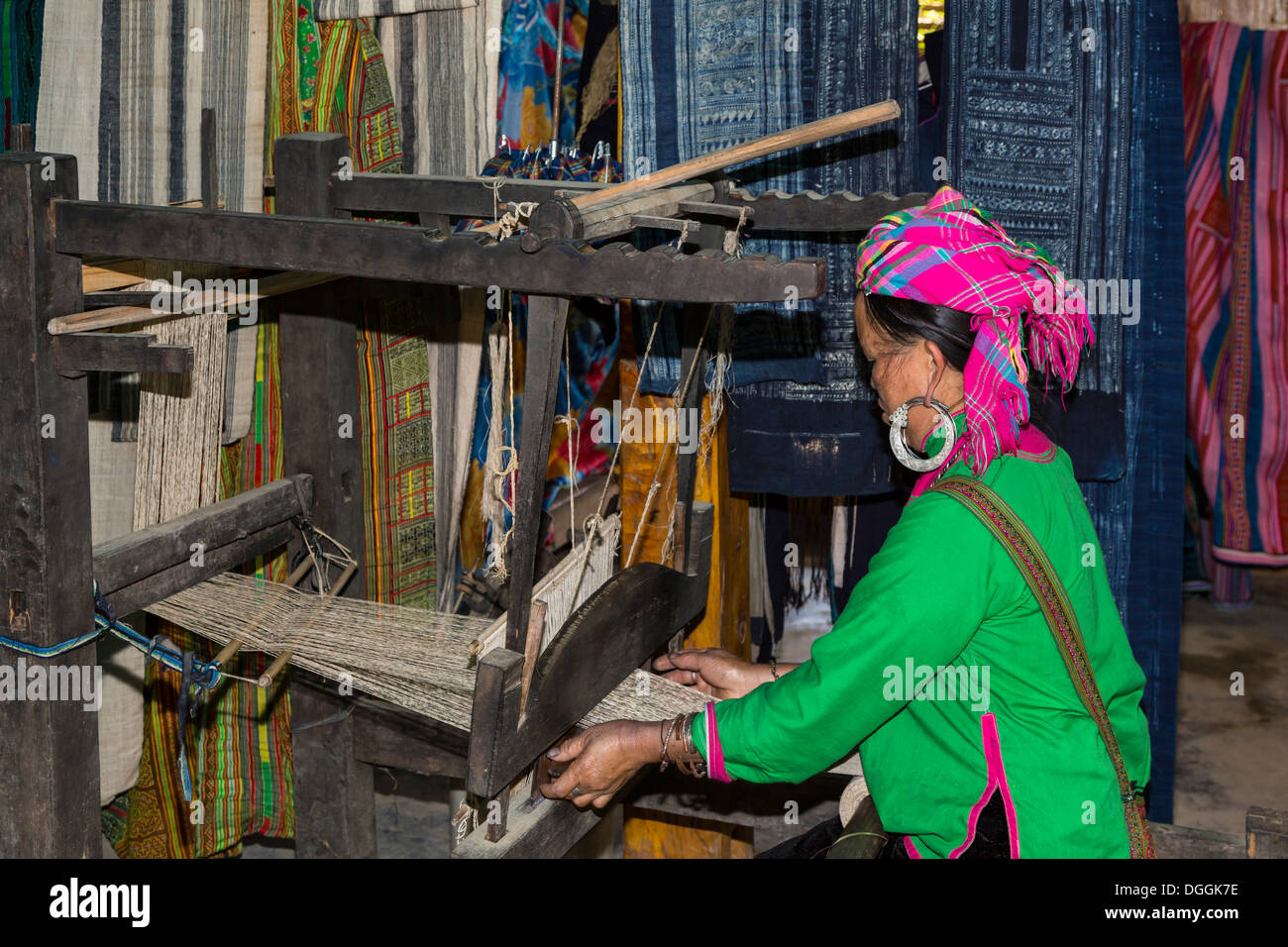 A Vietnamese hill-tribe lady weaving at a loom at Lao Chai village near ...