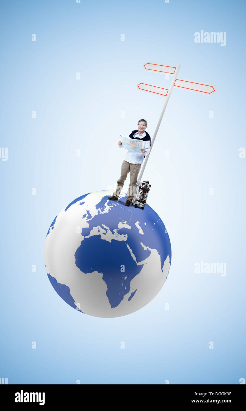 a man standing on the globe with a map Stock Photo - Alamy
