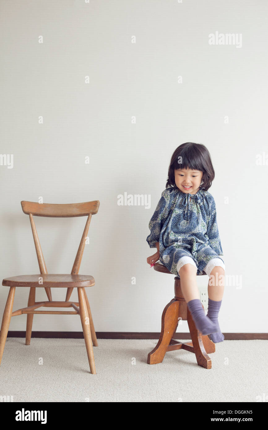 Girl sitting on stool hi-res stock photography and images - Alamy