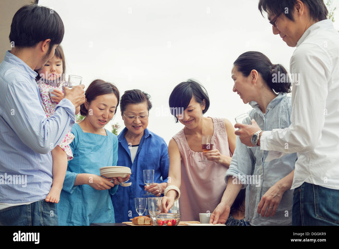 Three generation family eating meal outdoors Stock Photo - Alamy