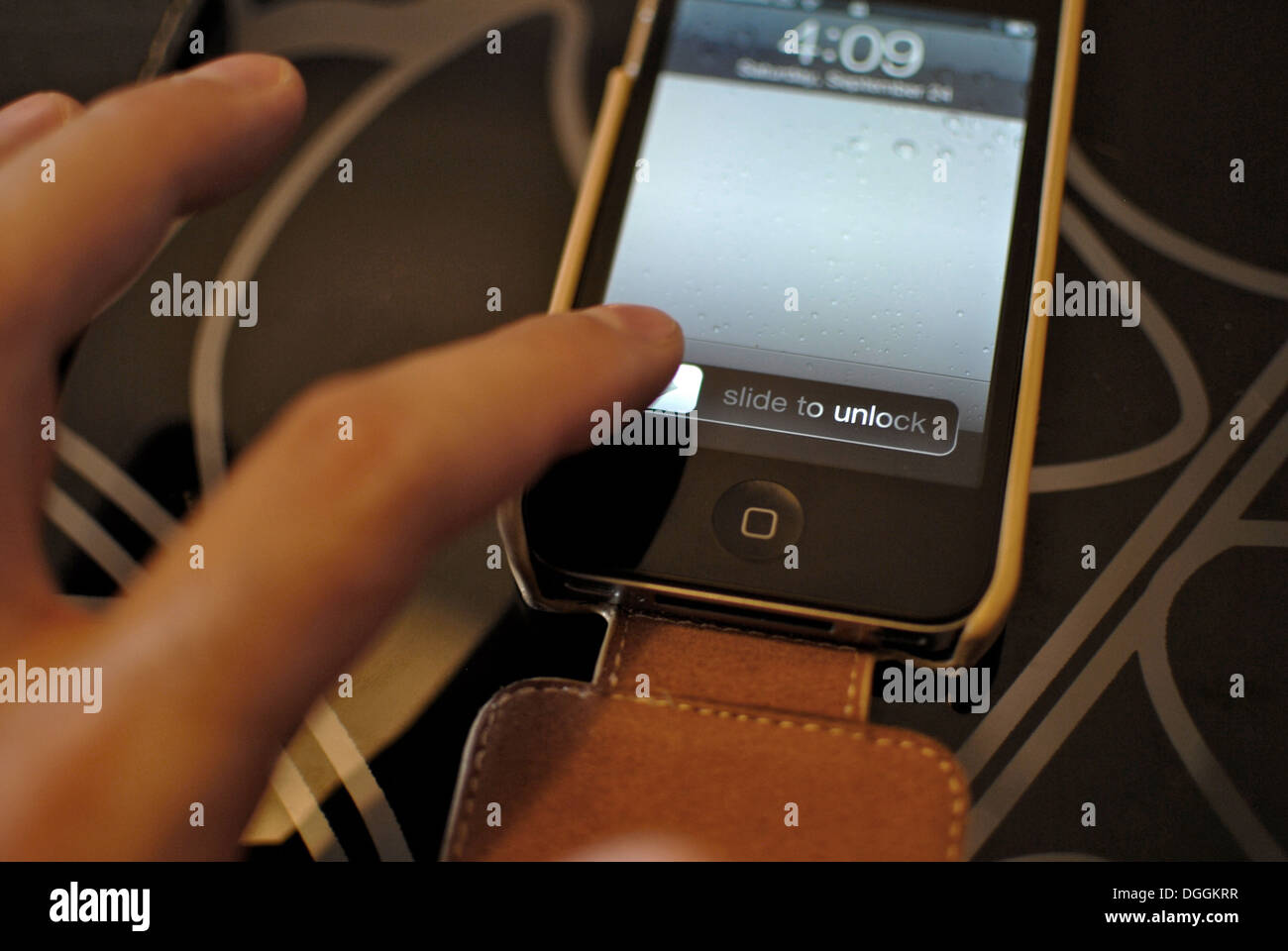Male hand sliding to unlock iPhone Stock Photo - Alamy
