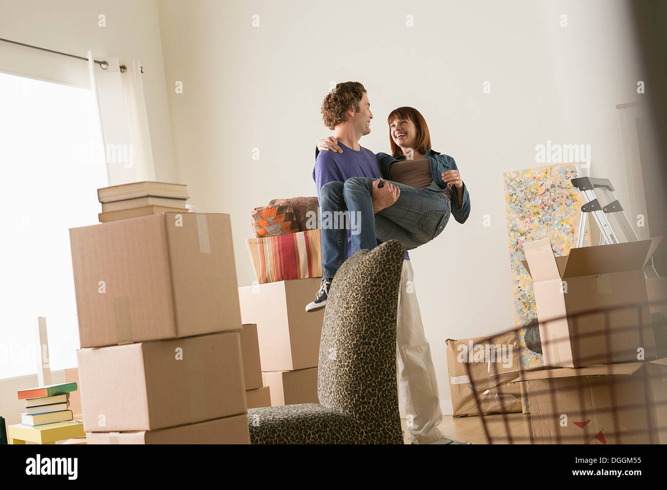 Couple having fun whilst moving Stock Photo - Alamy