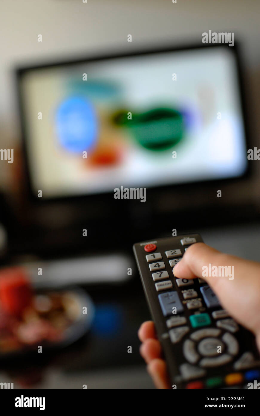 Close up of hand using a TV Remote Control Stock Photo - Alamy