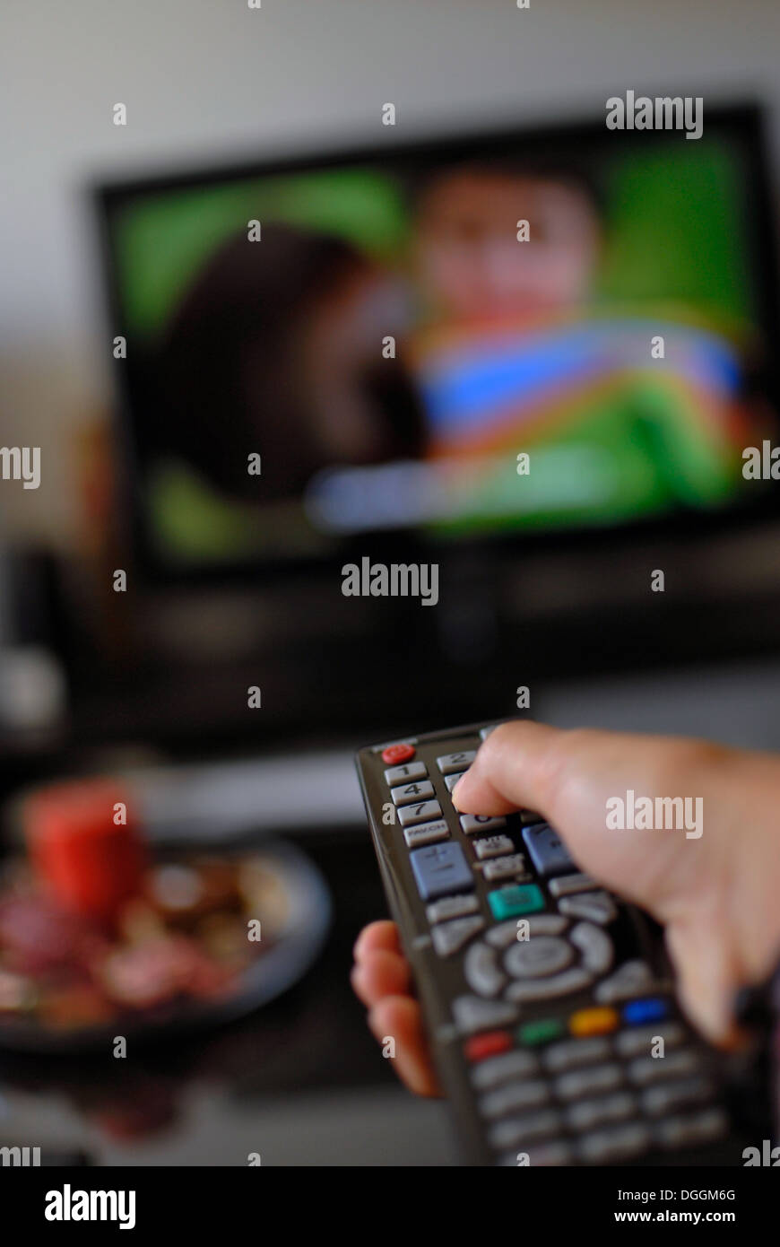 Close up of hand using a TV Remote Control Stock Photo - Alamy