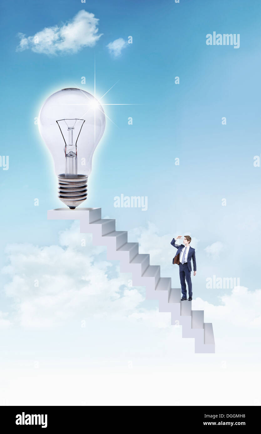 a business man climbing up stairs to a light bulb Stock Photo - Alamy