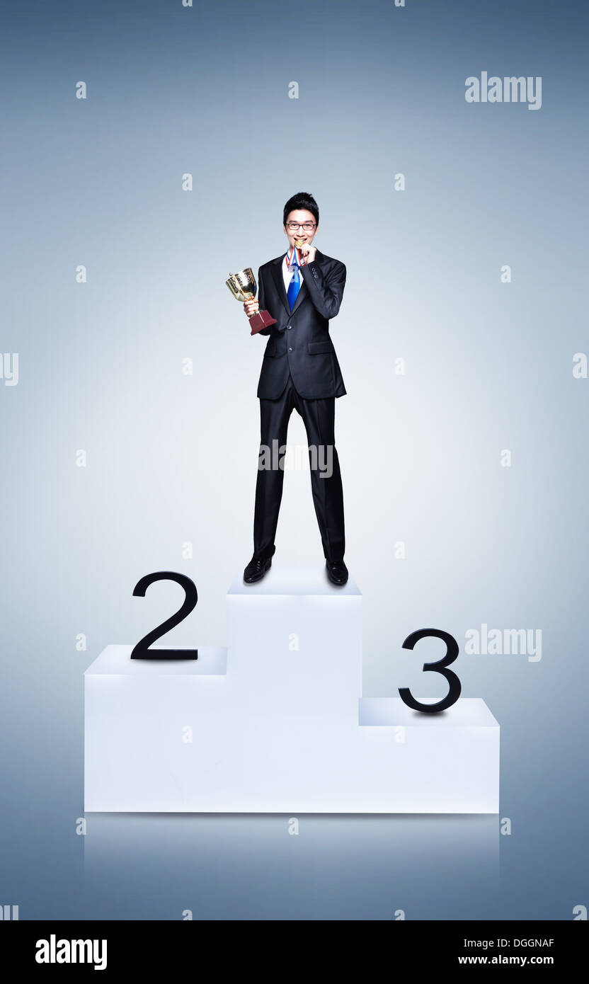 a business man standing on the first podium place Stock Photo - Alamy