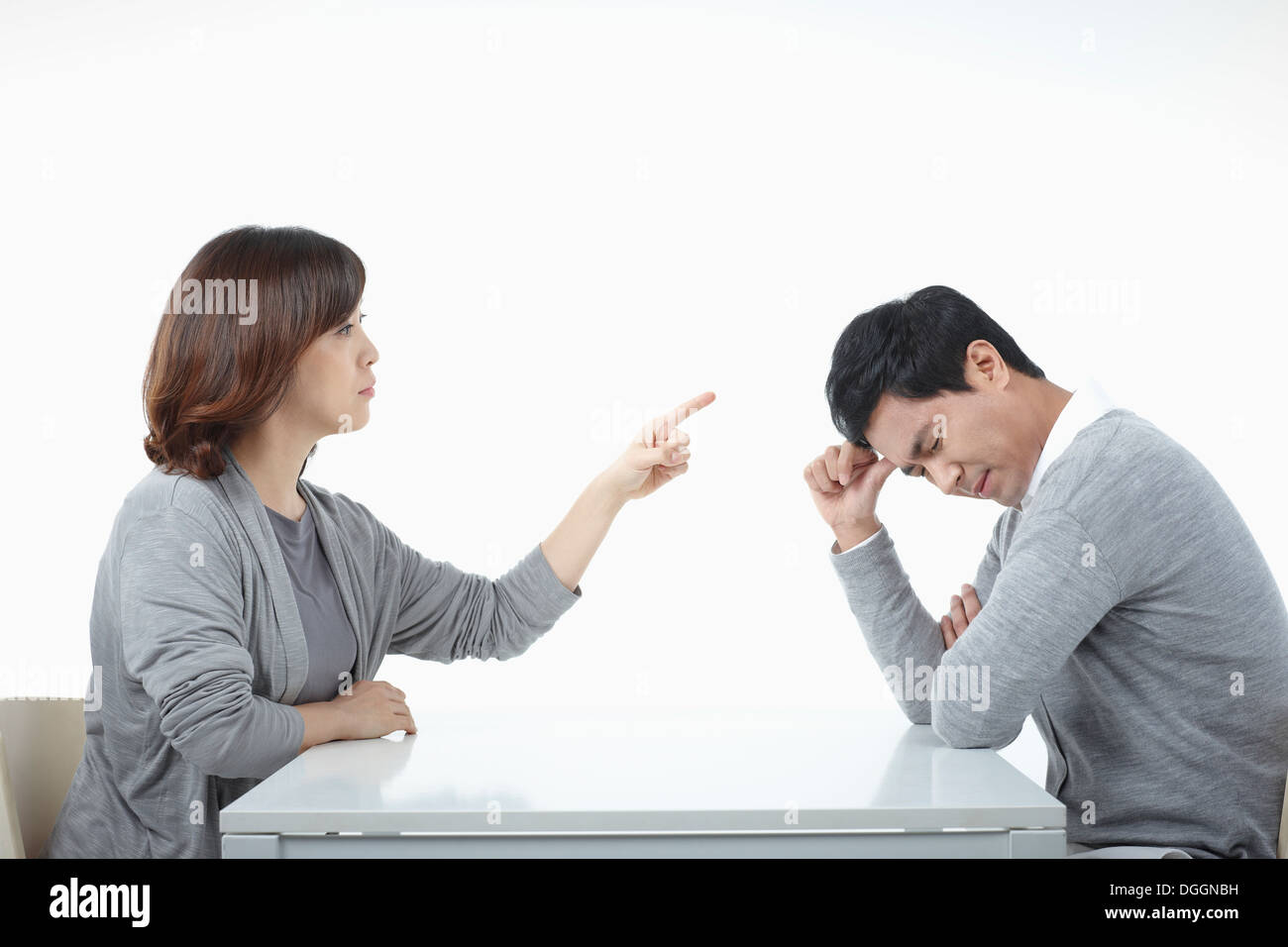 a man and a woman sitting at a table arguing Stock Photo - Alamy