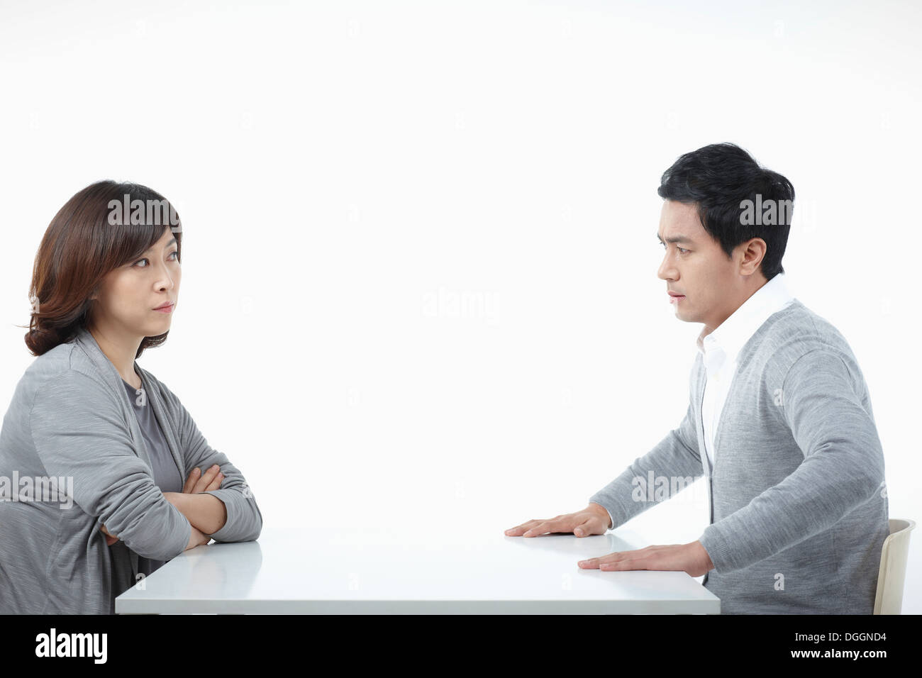 a man and a woman sitting at a table arguing Stock Photo - Alamy