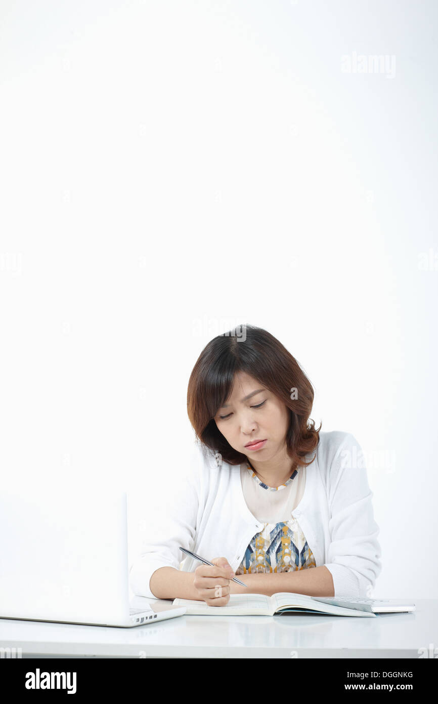 Asian woman thinking writing hi-res stock photography and images - Alamy