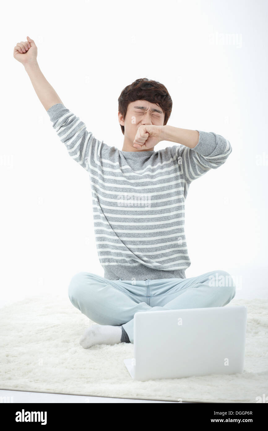 a boy sitting down with a laptop Stock Photo - Alamy