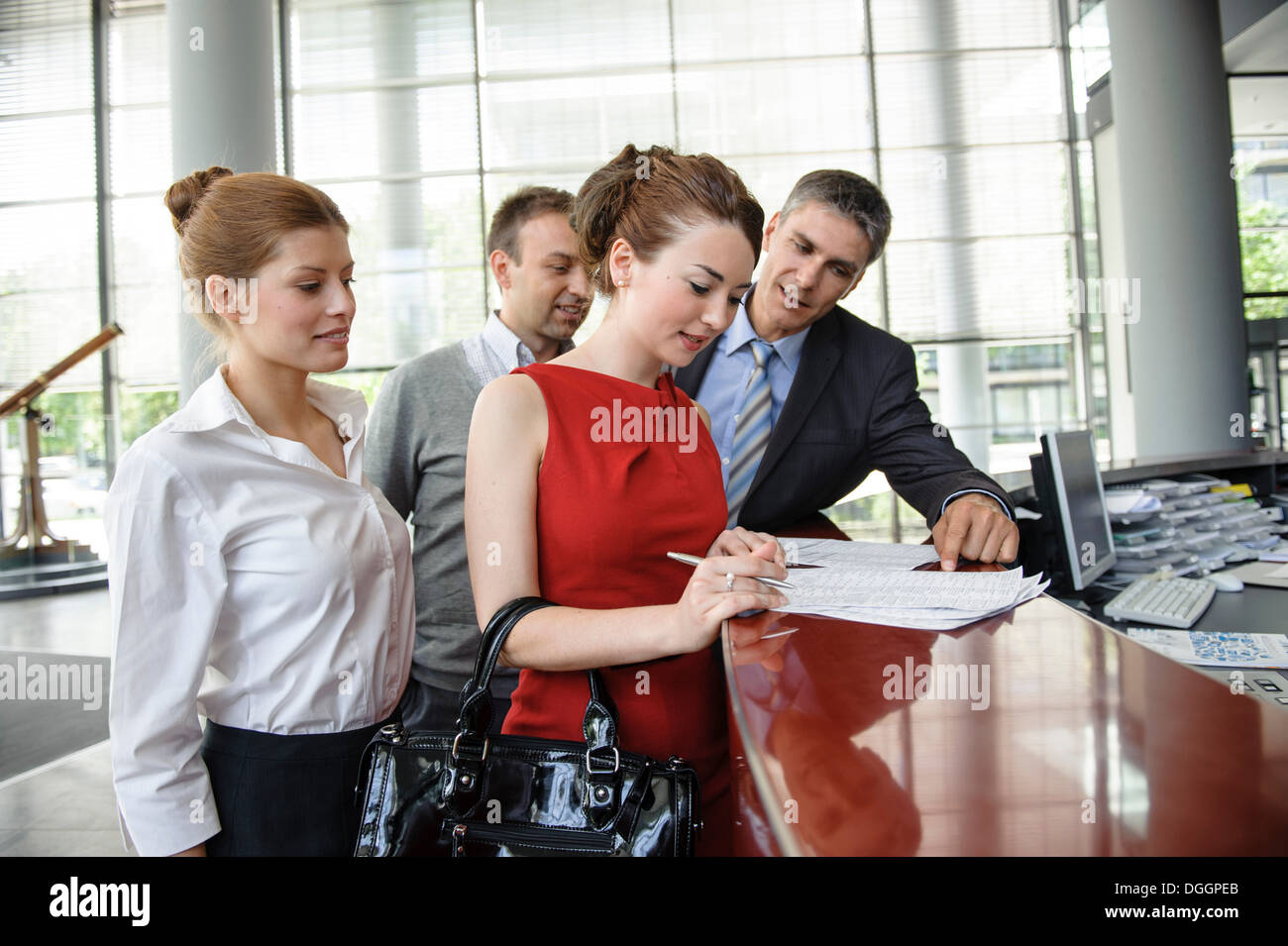 Man signing reception desk people hi-res stock photography and images ...
