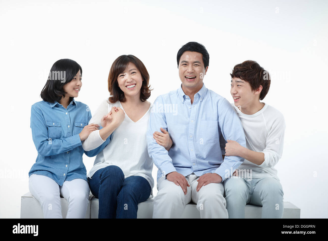 family sitting together Stock Photo - Alamy