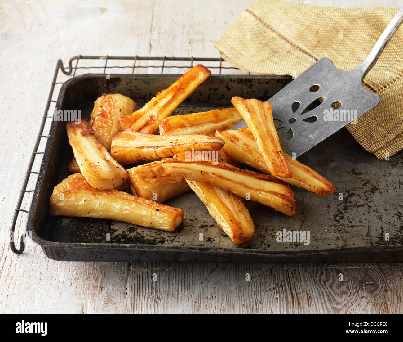 Roast parsnips on baking tray and wire rack Stock Photo - Alamy