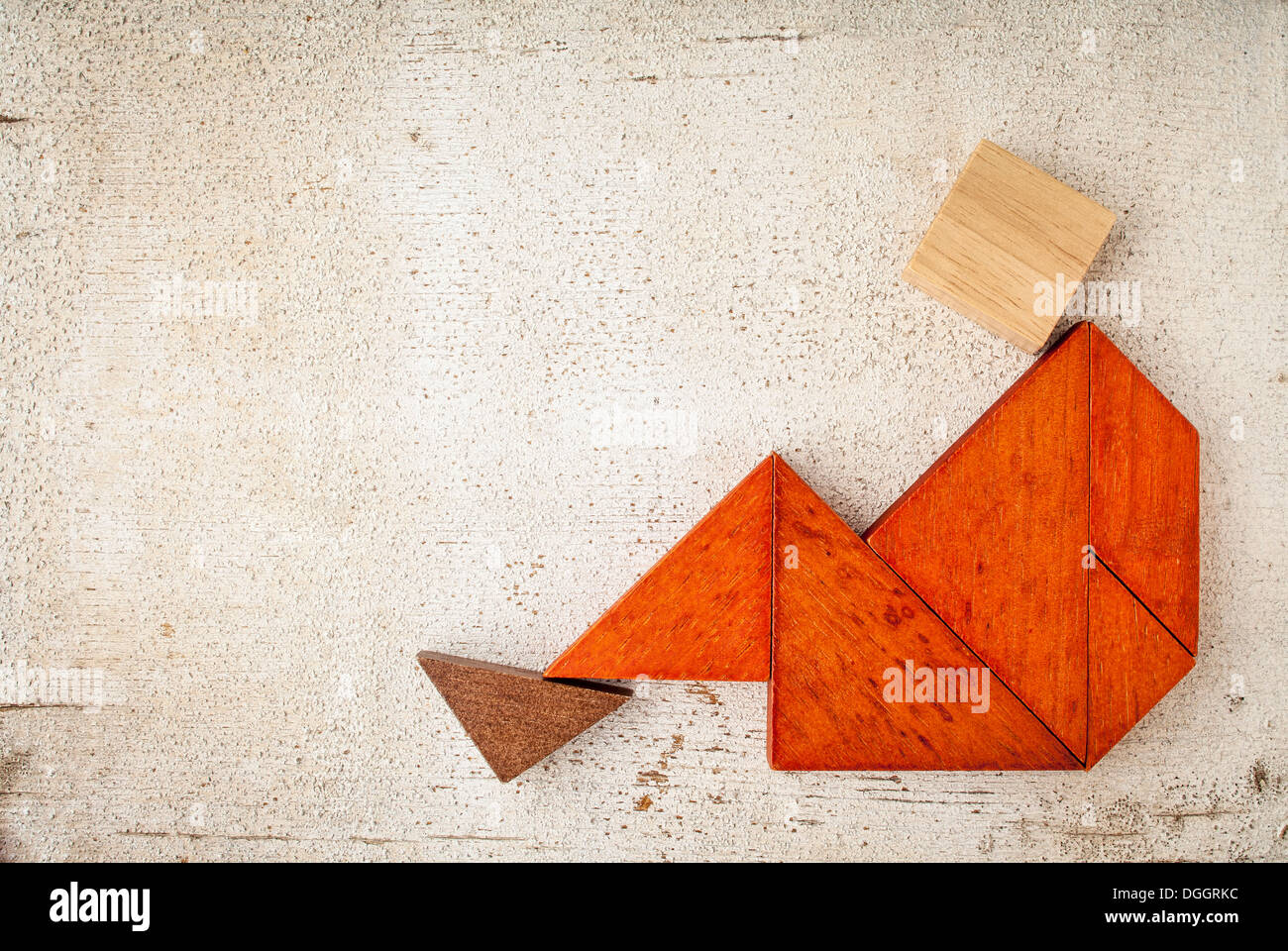 abstract sitting or relaxing figure built from seven tangram wooden ...