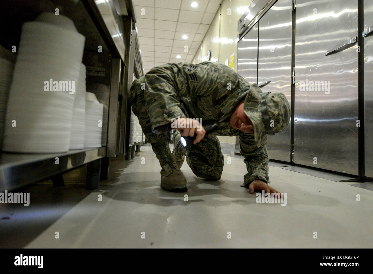 Senior Airman Jordan Hocker inspects for pests in the dining facility ...