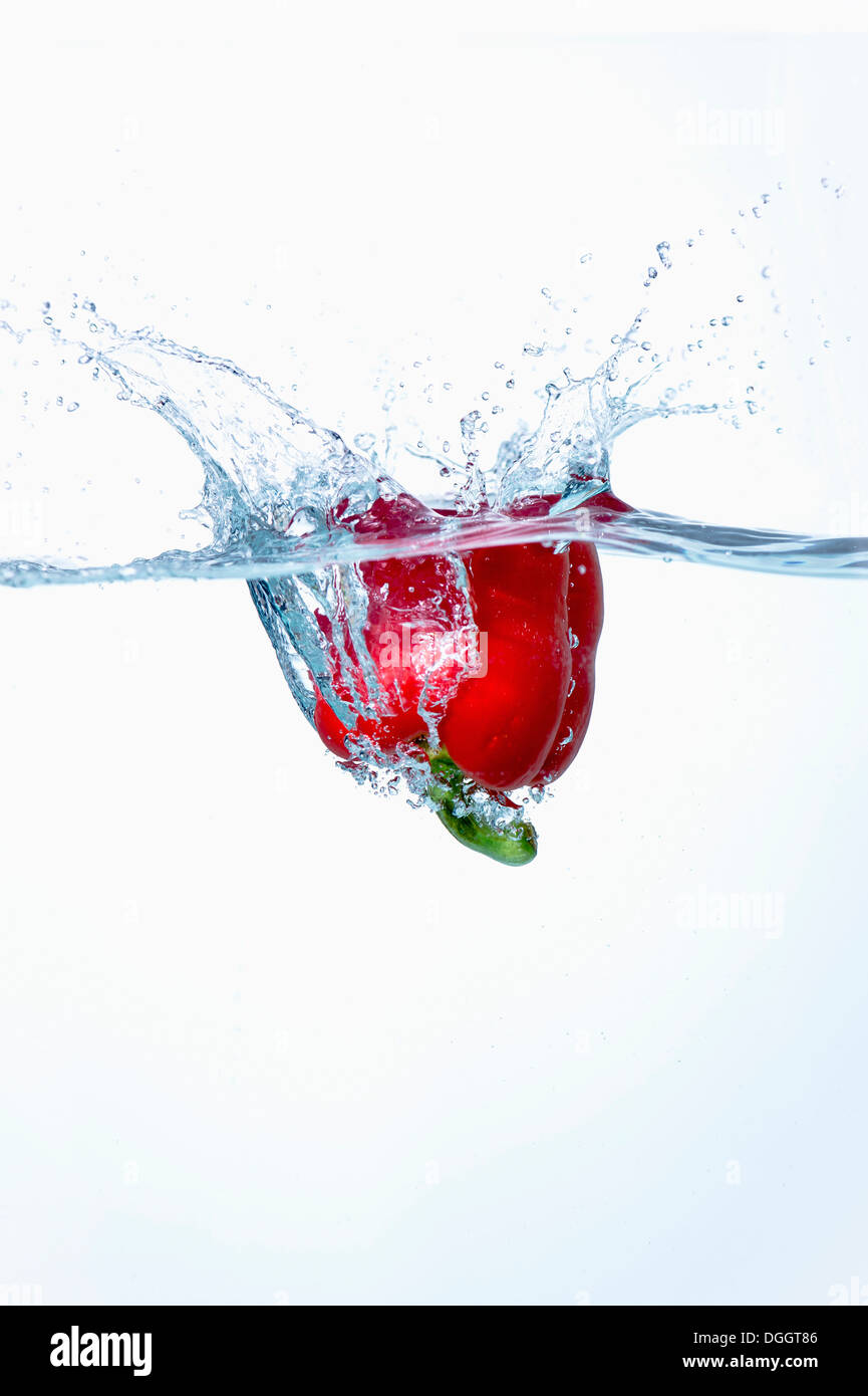 a red paprika falling in to water Stock Photo - Alamy
