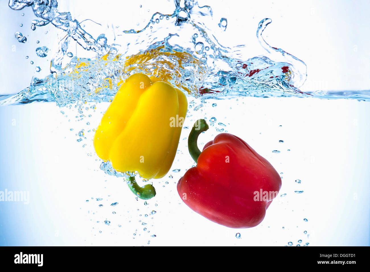 different color paprika falling in to water Stock Photo - Alamy