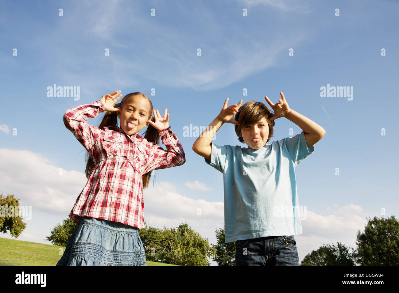 Boy and girl pulling faces Stock Photo - Alamy