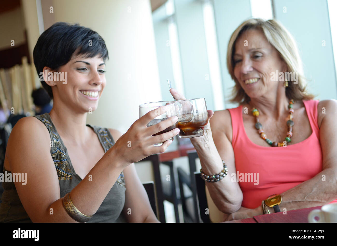 Young and mature women drink a toast Stock Photo - Alamy