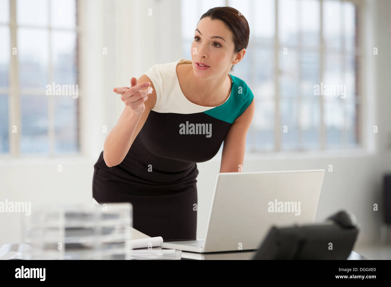 Female office worker using laptop Stock Photo - Alamy