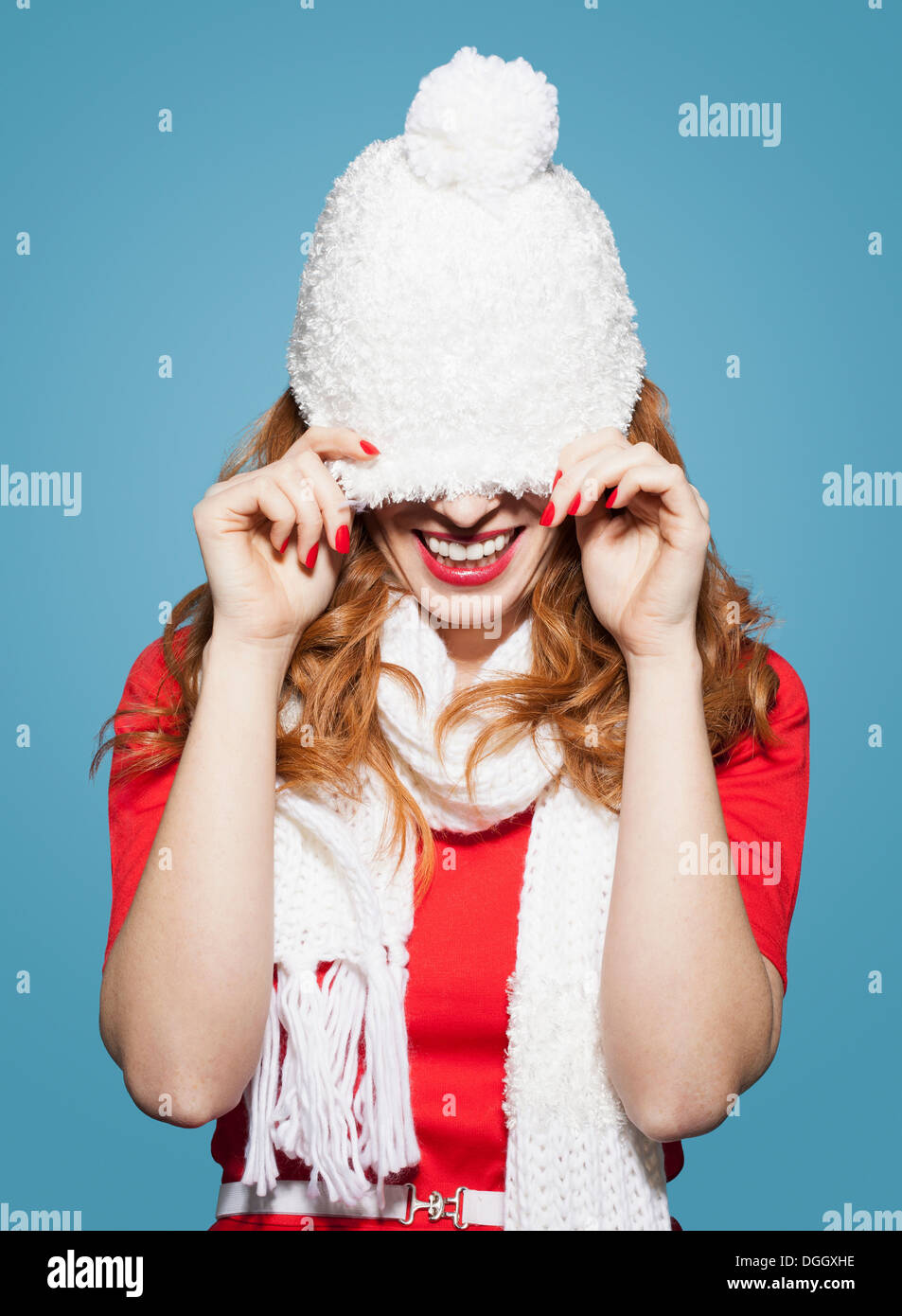 Woman pulling white bobble hat over eyes Stock Photo - Alamy
