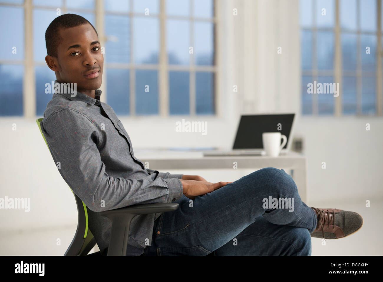 Male office worker sitting at desk Stock Photo - Alamy