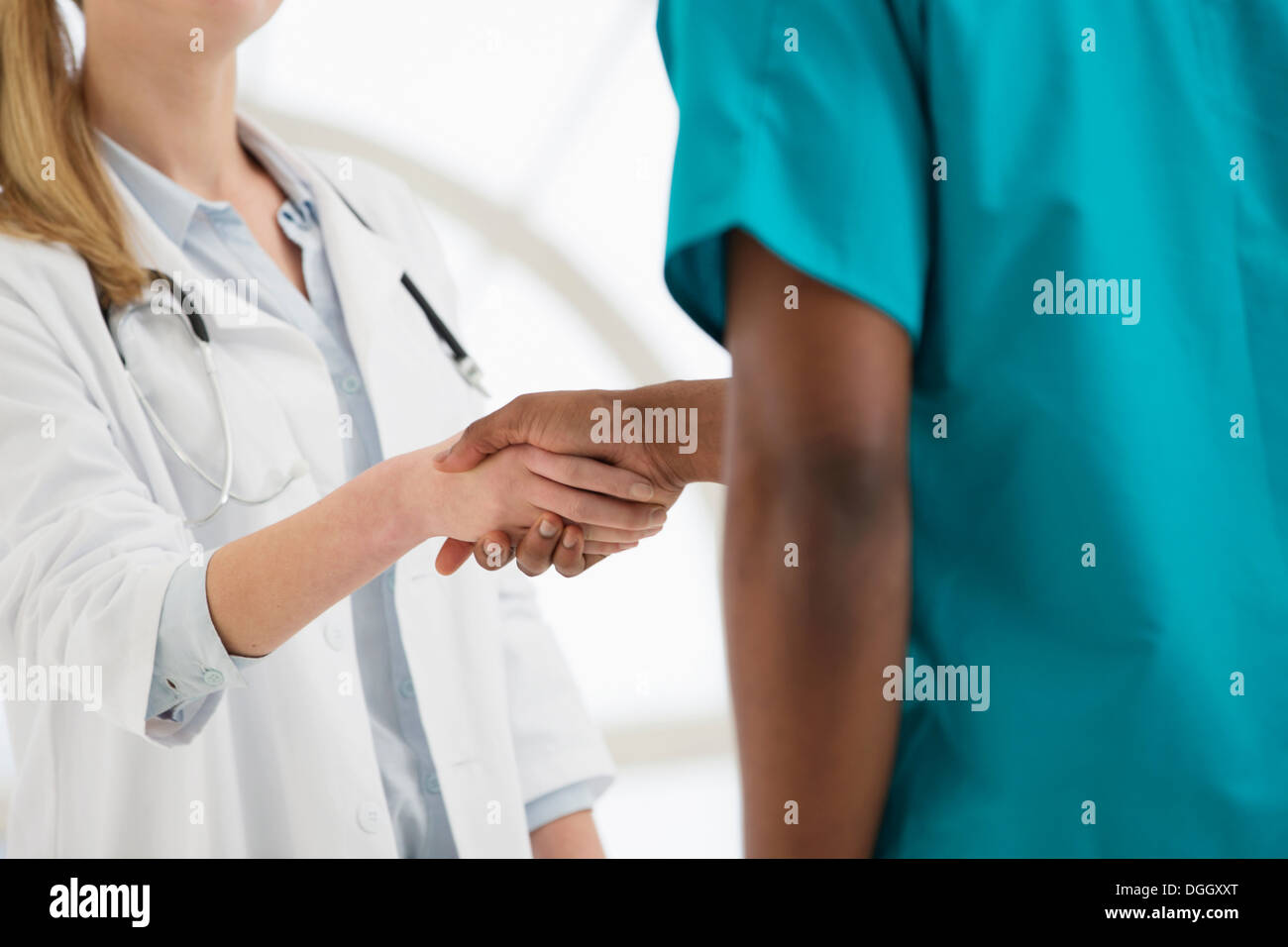 Two doctors shaking hands, mid section Stock Photo - Alamy