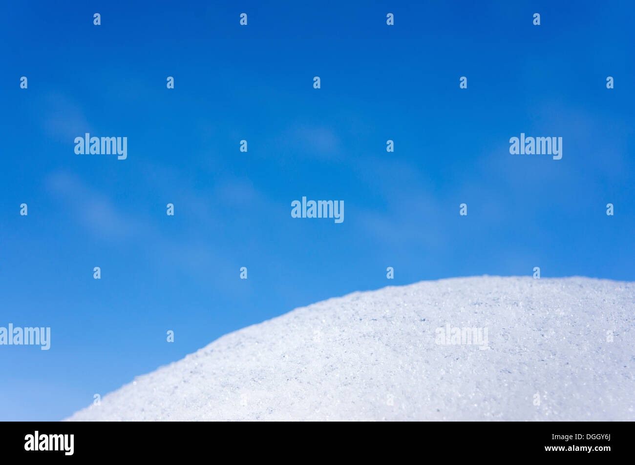 White snow isolated against blue skies with shallow depth of field ...