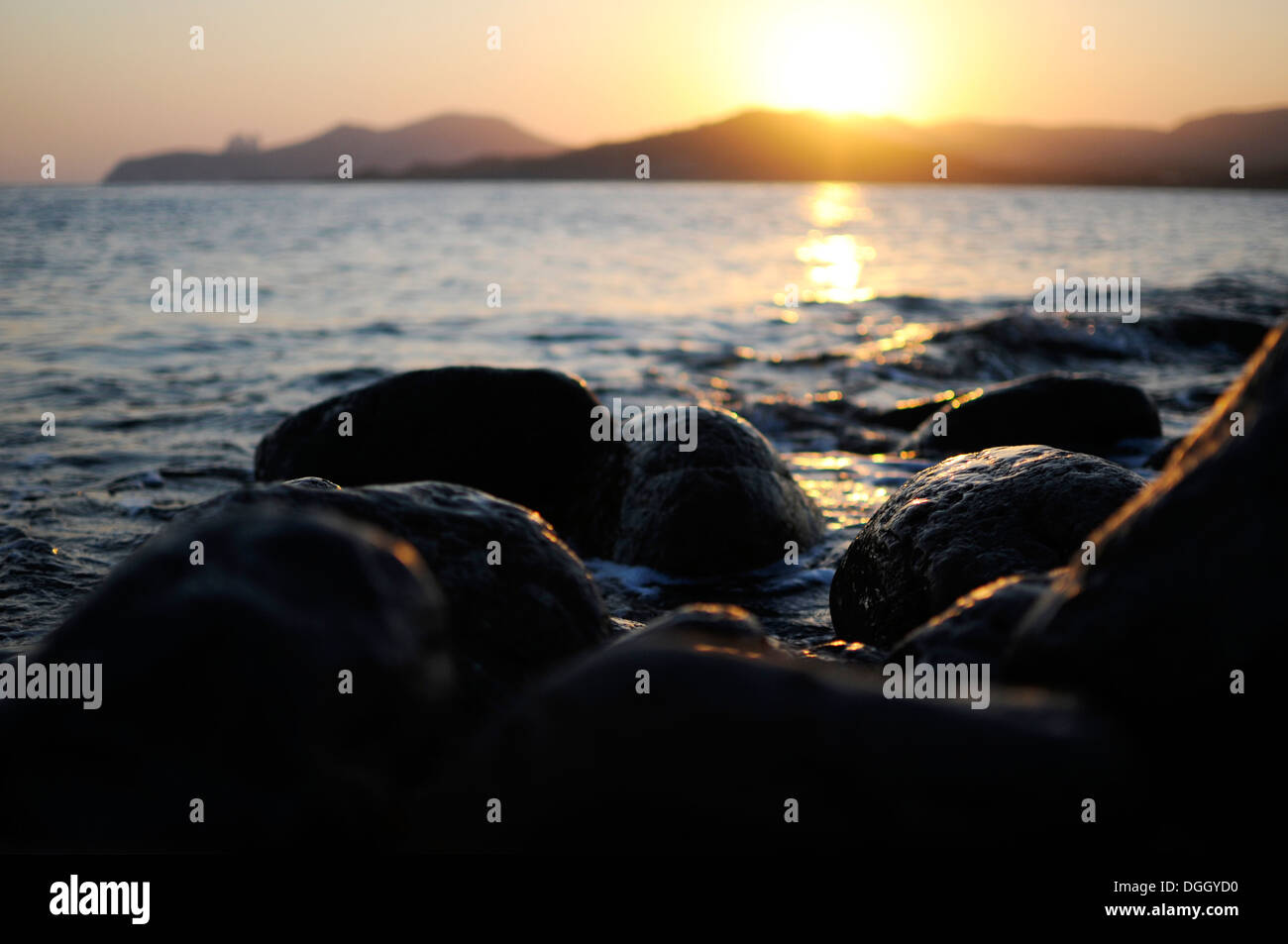 Water hits the rocks in a beautiful sunset, Ibiza Stock Photo - Alamy