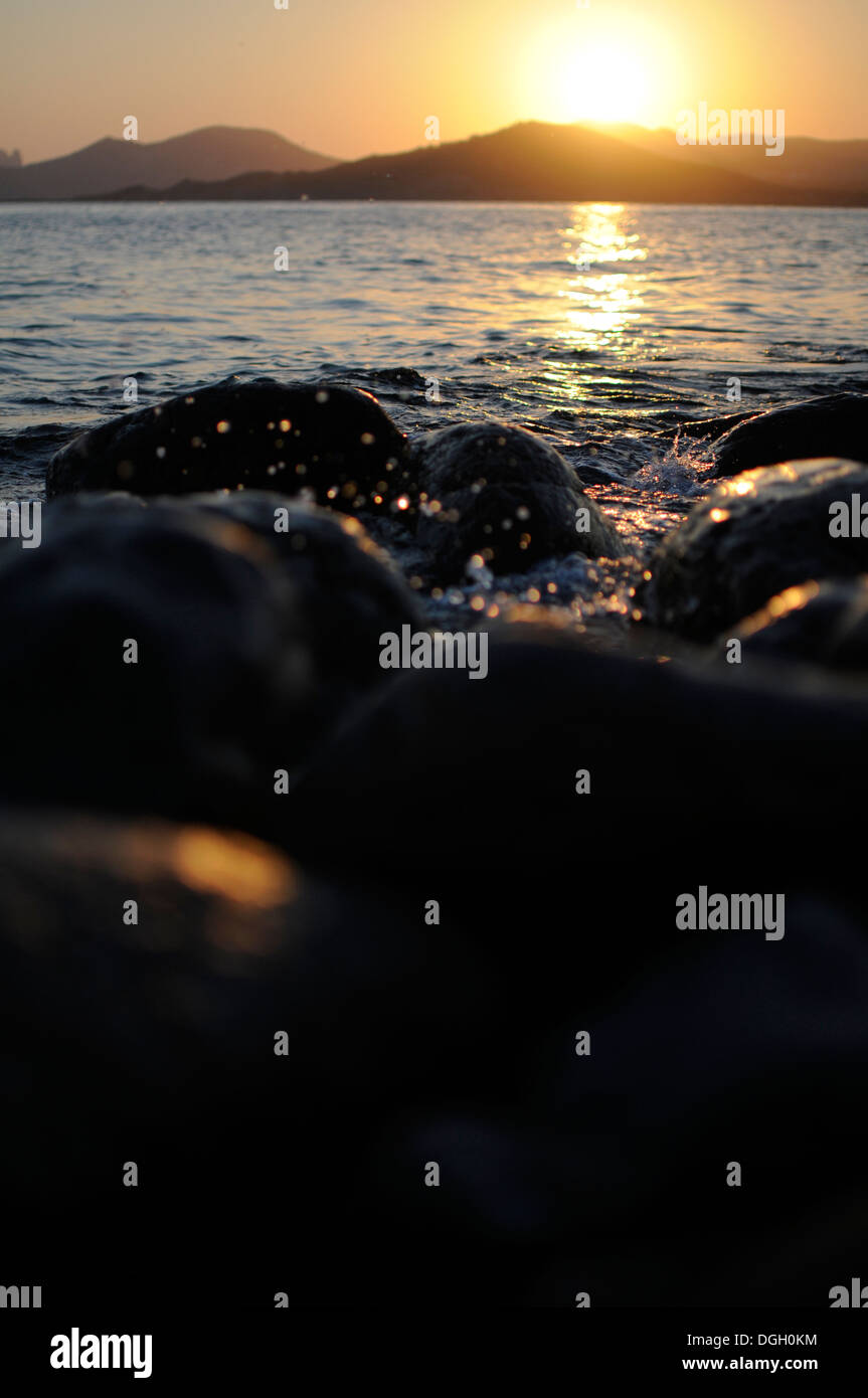 Water hits the rocks in a beautiful sunset, Ibiza Stock Photo - Alamy