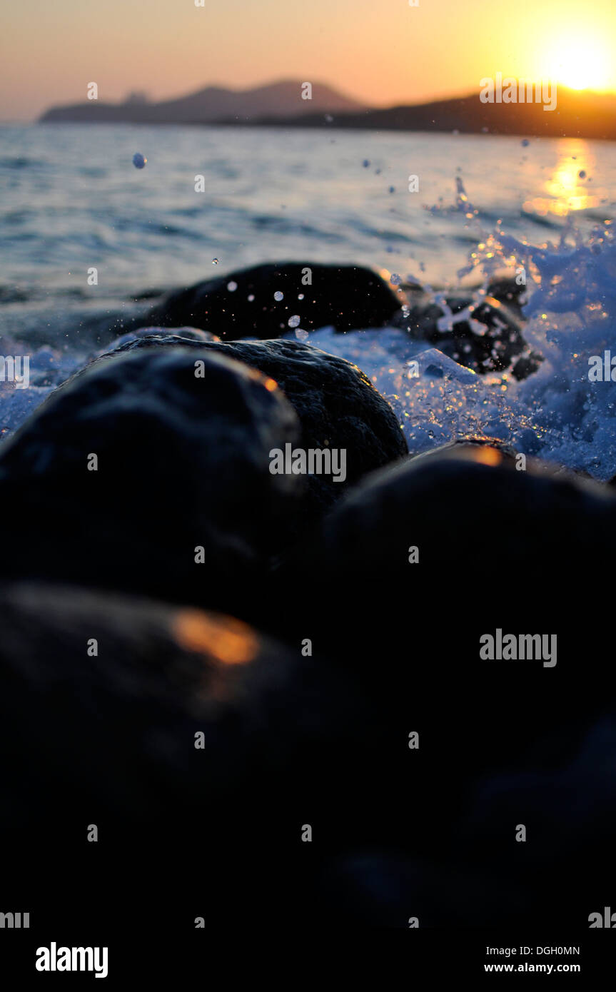 Water hits the rocks in a beautiful sunset, Ibiza Stock Photo - Alamy