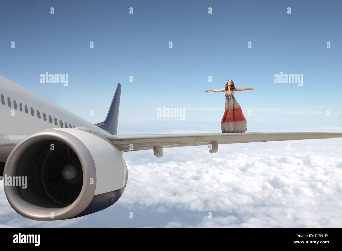 Woman with open arms on the left wing of an airplane Stock Photo - Alamy