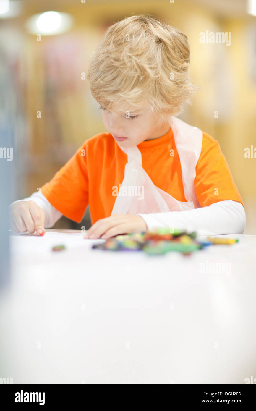 Boy concentrating on drawing Stock Photo - Alamy