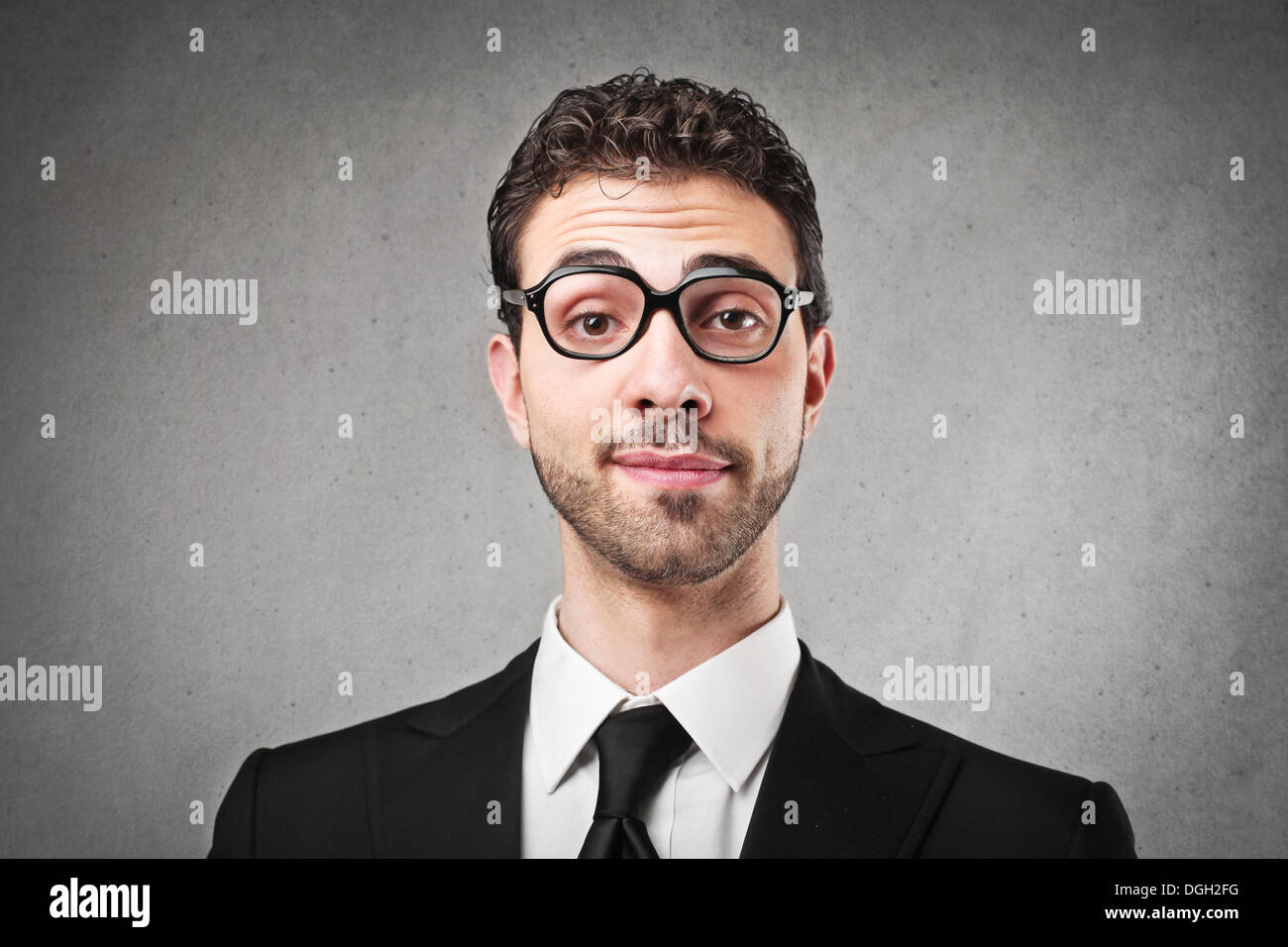 Young businessman with glasses and a strange expression Stock Photo - Alamy