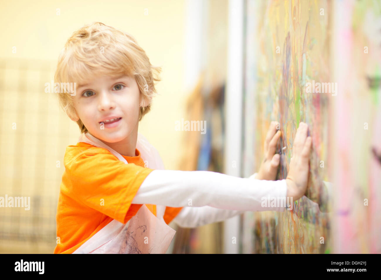 Boy touching painting Stock Photo - Alamy